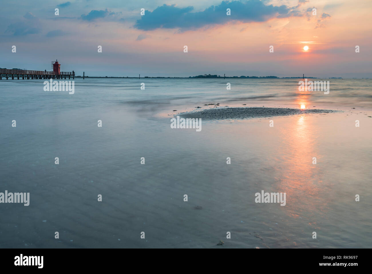 Lignano Sabbiadoro. Pier of the two lighthouses. Sunrise Stock Photo ...