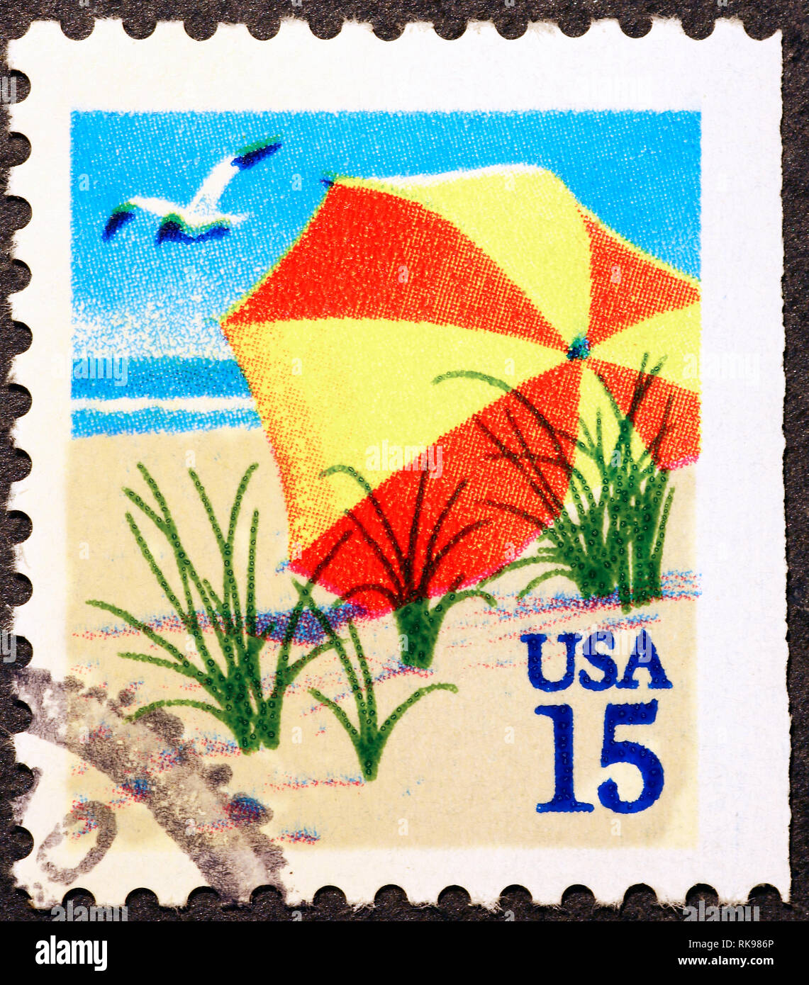 Beach umbrella and seaside on american postage stamp Stock Photo - Alamy