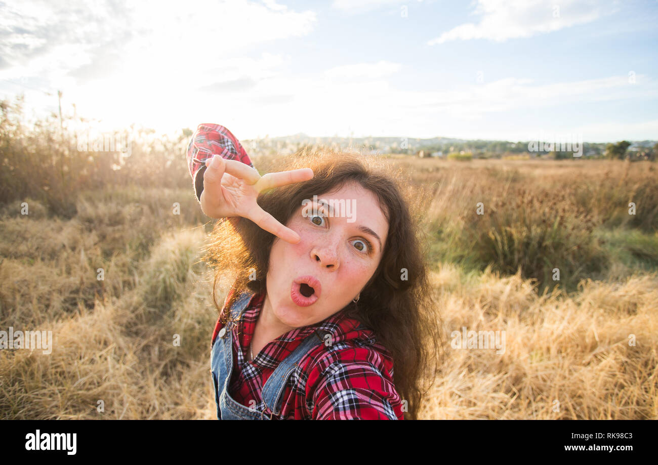 Travel, tourism and nature concept - Young woman fooling around taking ...