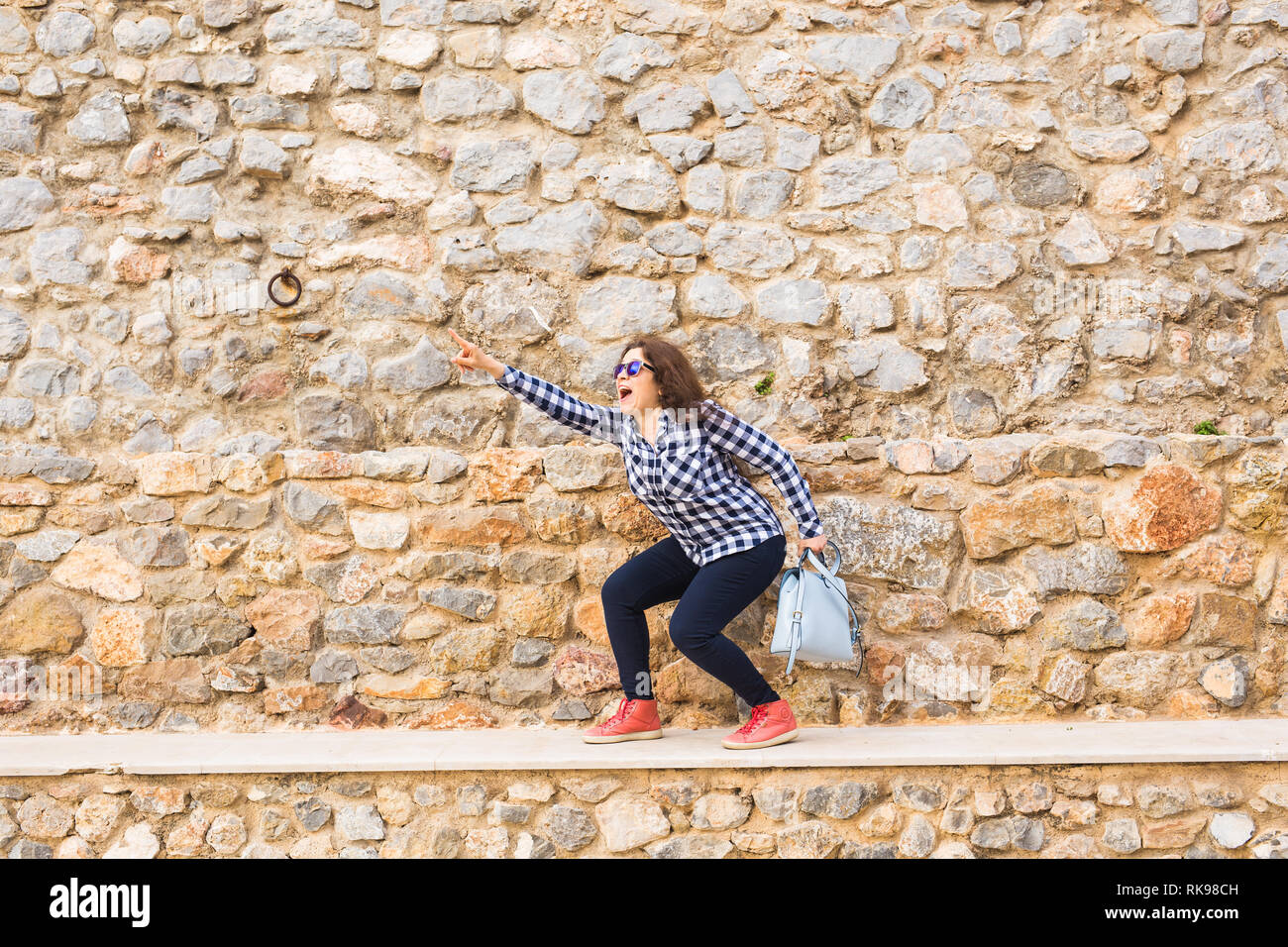 Emotions and gestures - Surprised young woman pointing something ...