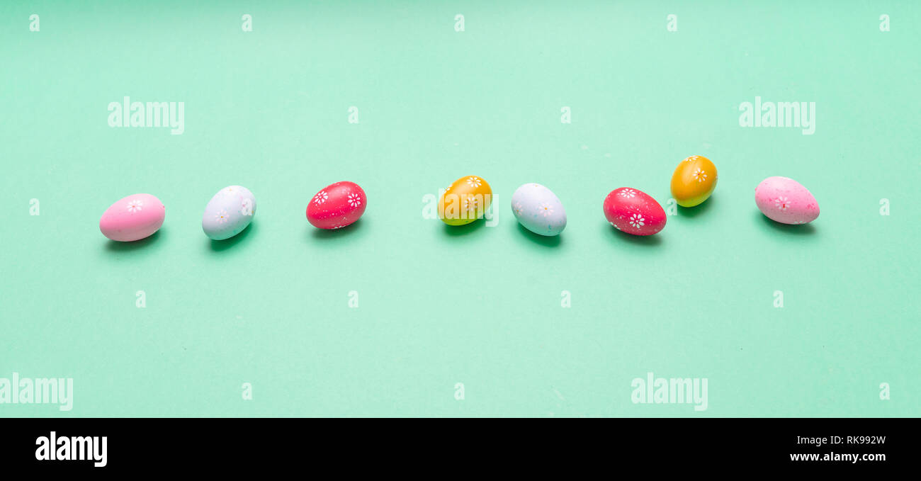 Easter eggs, pastel colors painted and decorated on green background ...