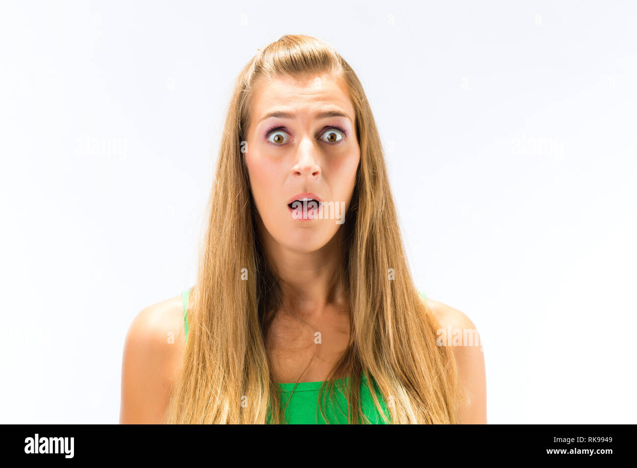 Scared young woman looking at camera Stock Photo - Alamy