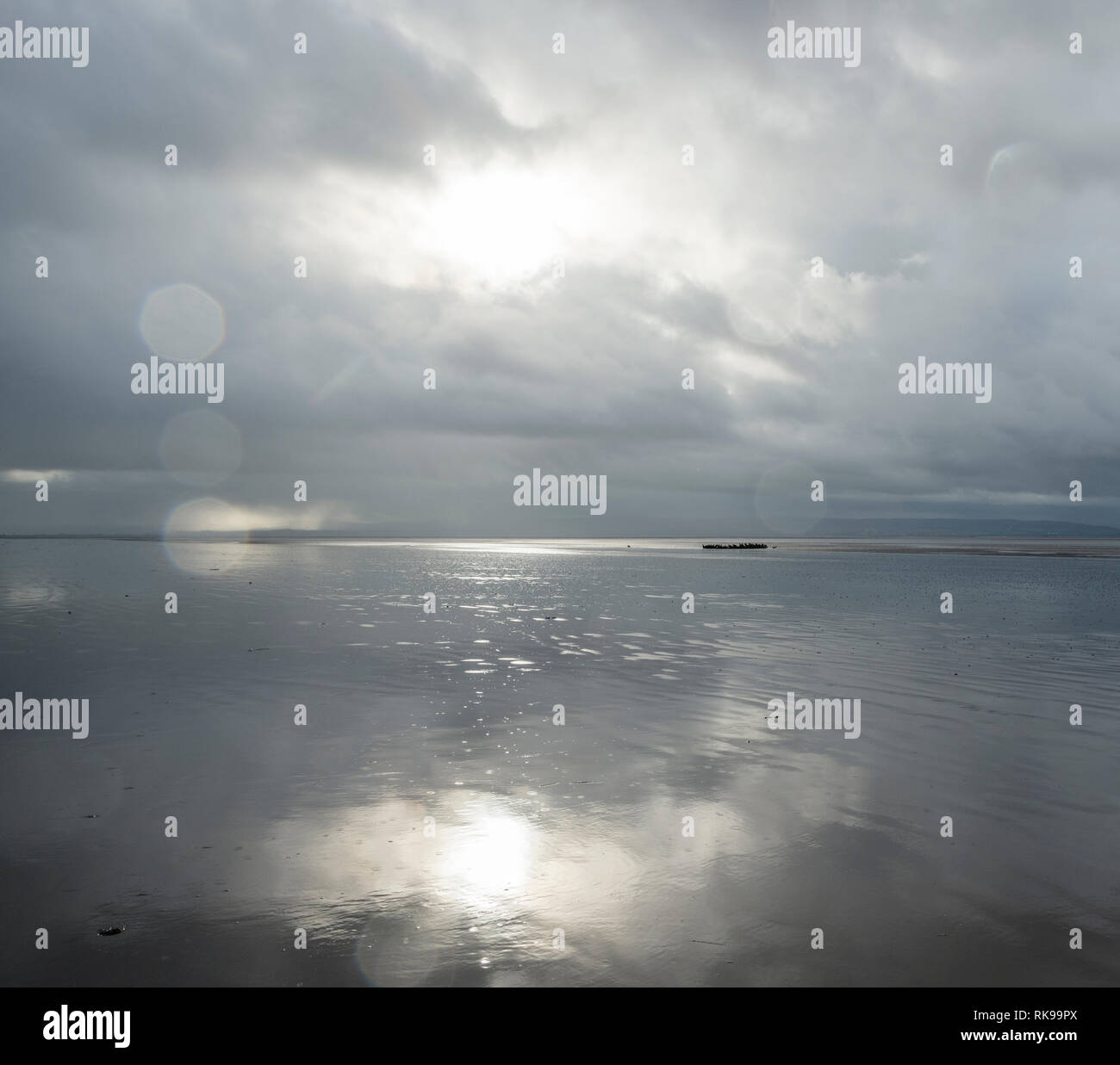 Raindrops on the lens cause flare during a rain storm at the beach ...