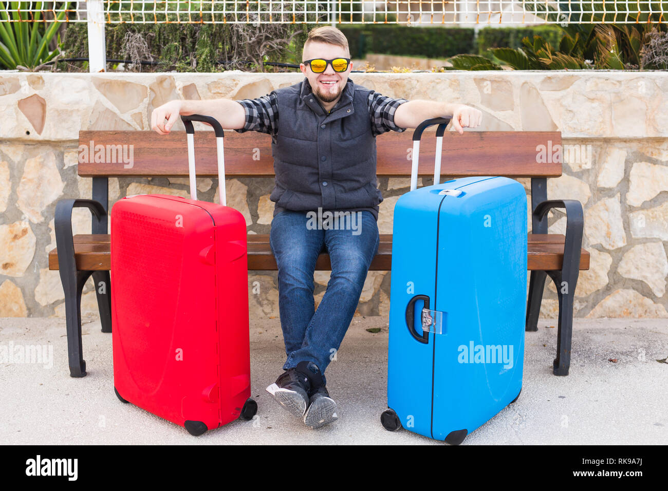 Travel, tourism and people concept - happy man sitting on a bench with ...