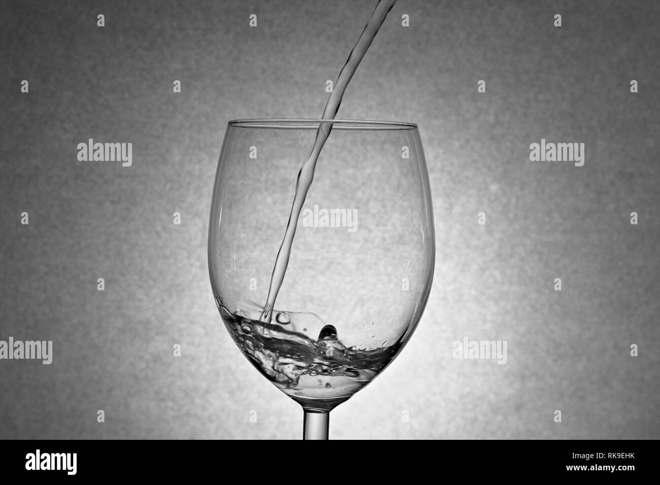 Water dripping into wine glass Stock Photo - Alamy