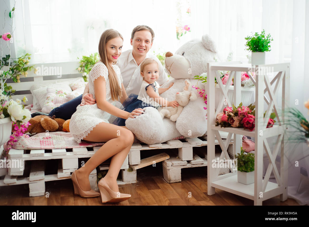 Lovely family smiling and laughing, posing at camera Stock Photo - Alamy