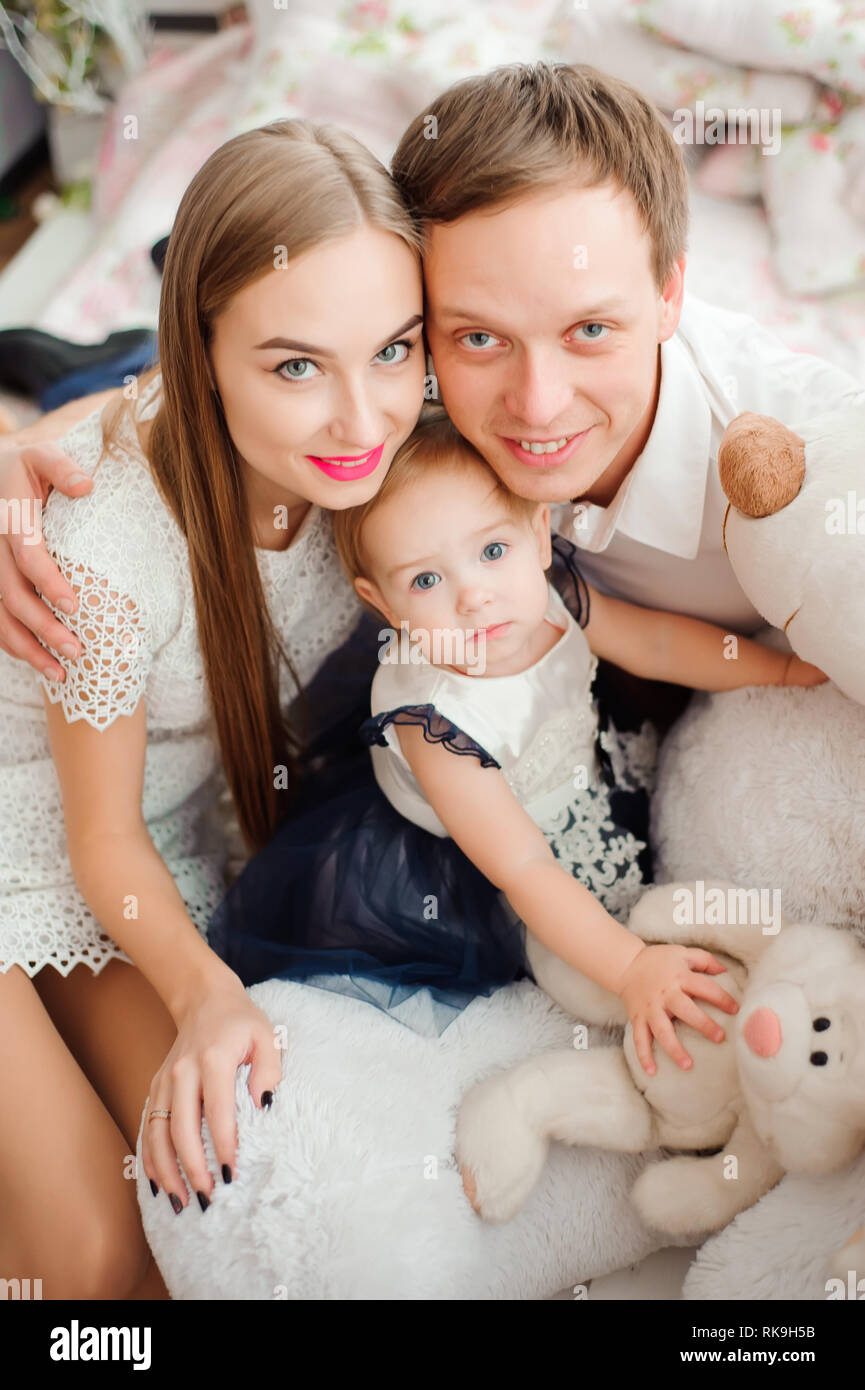 Lovely family smiling and laughing, posing at camera Stock Photo - Alamy