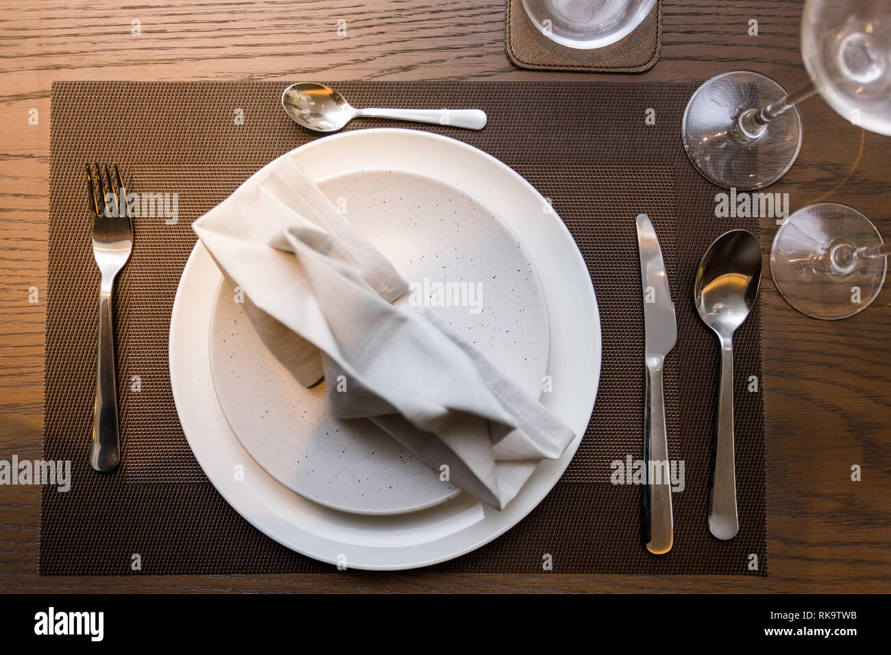 Table setting in modern style dining room Stock Photo - Alamy