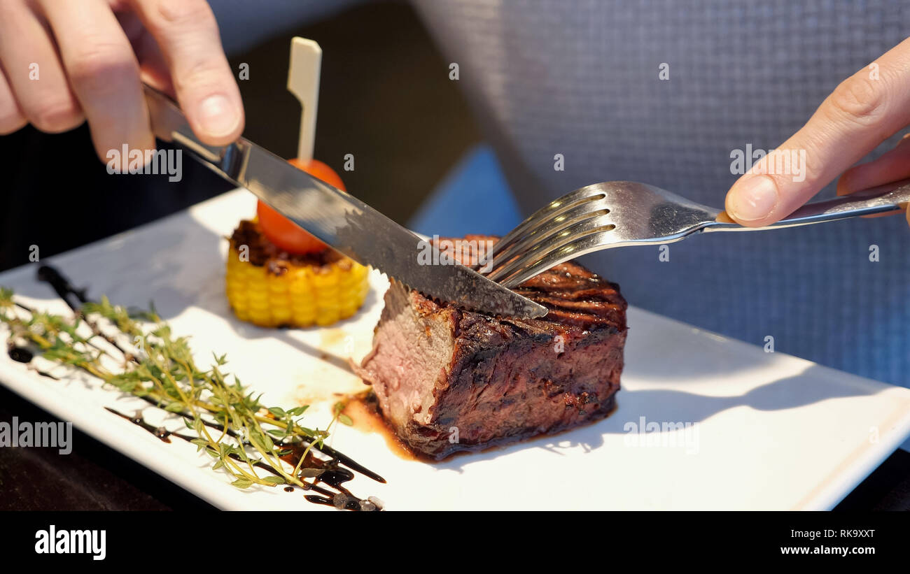 male hands cuts meat Stock Photo - Alamy