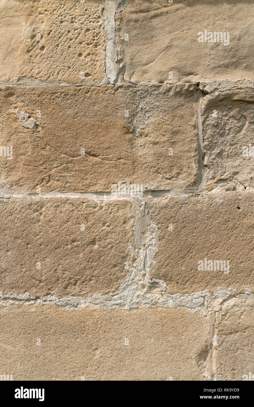 Close up of old stone wall with thick grout and very rough surface ...