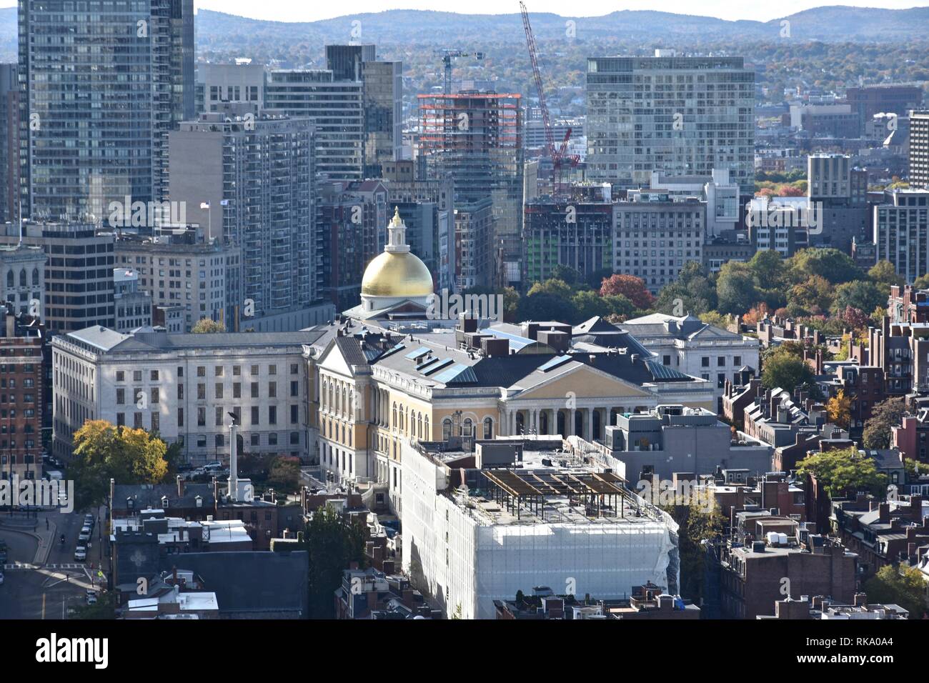 The gold dome of the Massachusetts State House atop Beacon Hill against ...
