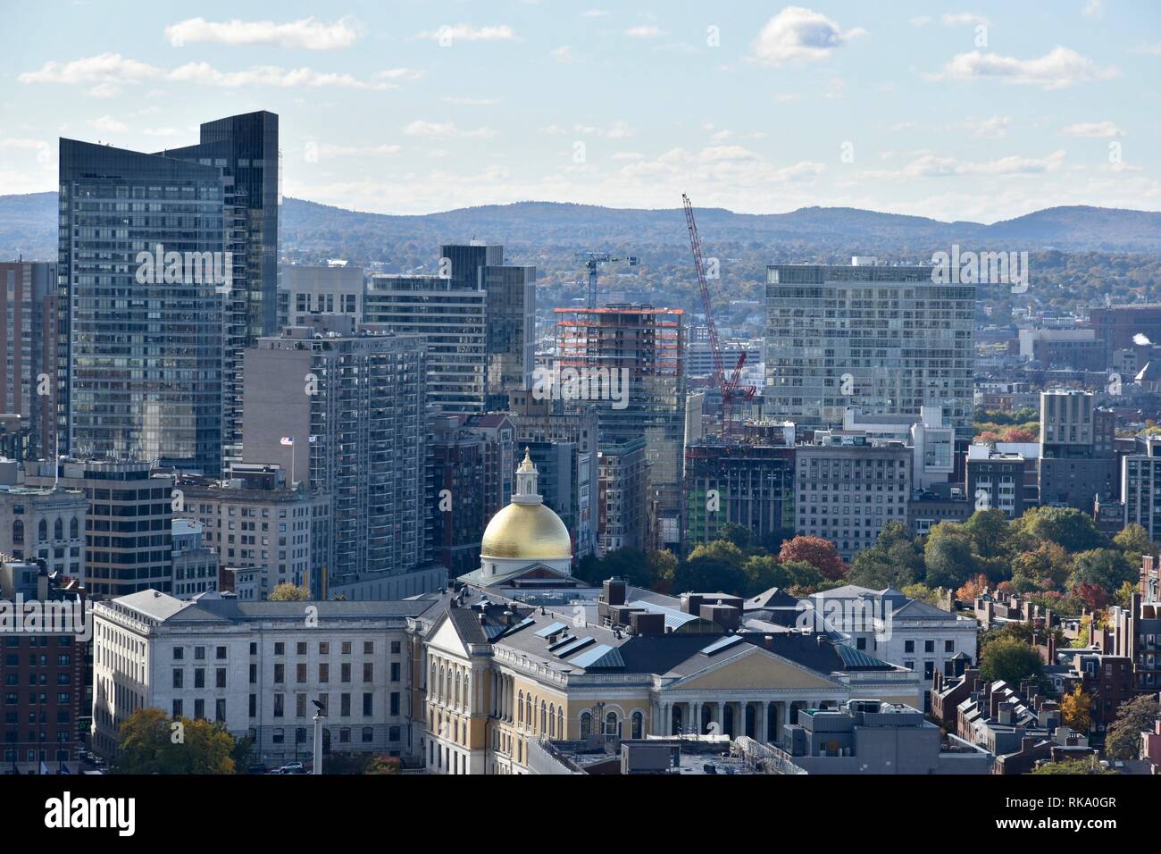 The gold dome of the Massachusetts State House atop Beacon Hill against ...
