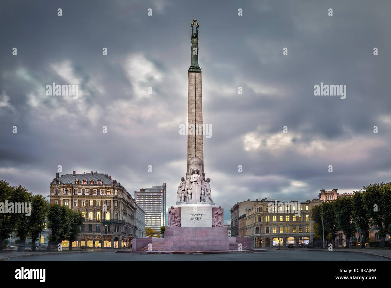 Monument of freedom in Riga. Woman holding three gold stars which ...