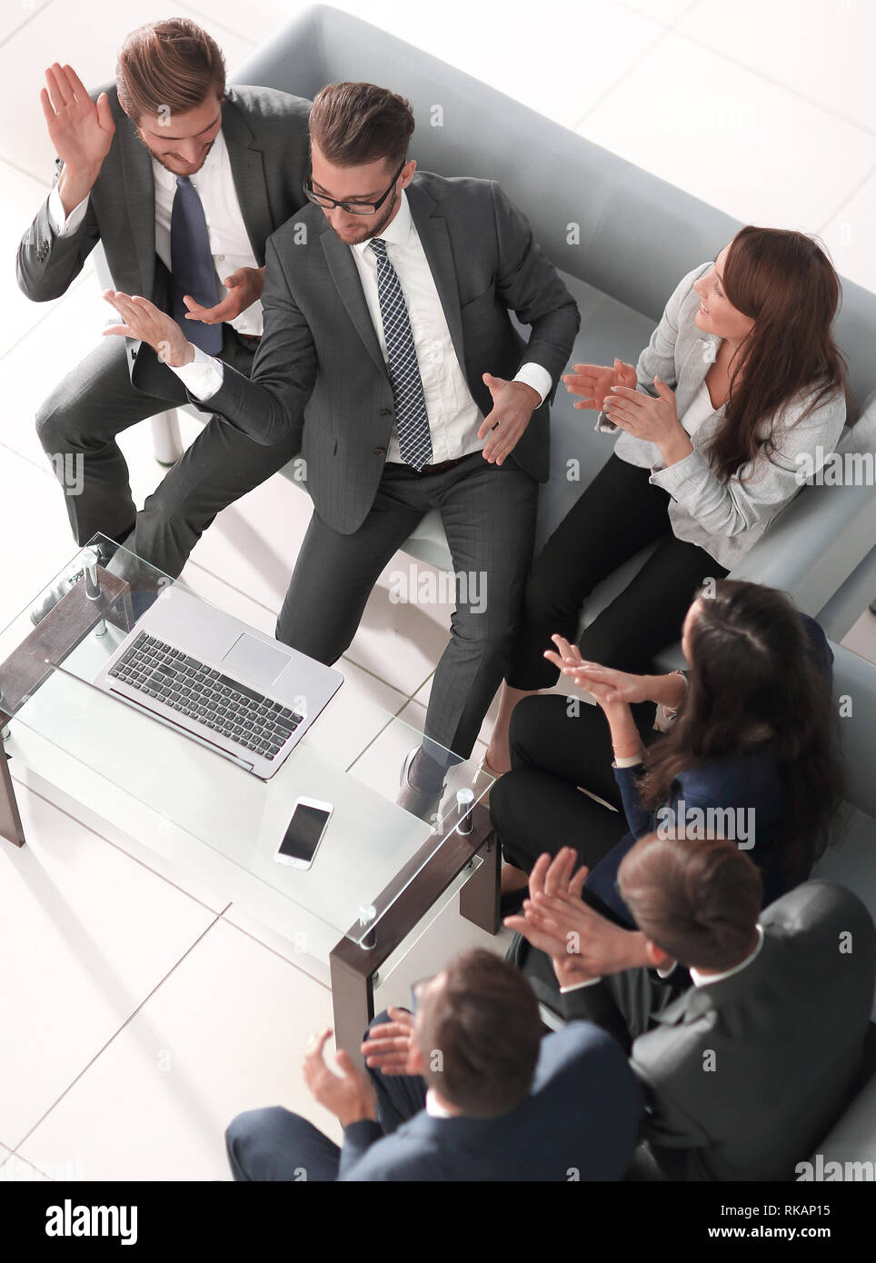 Happy successful business team giving a high fives gesture as they ...