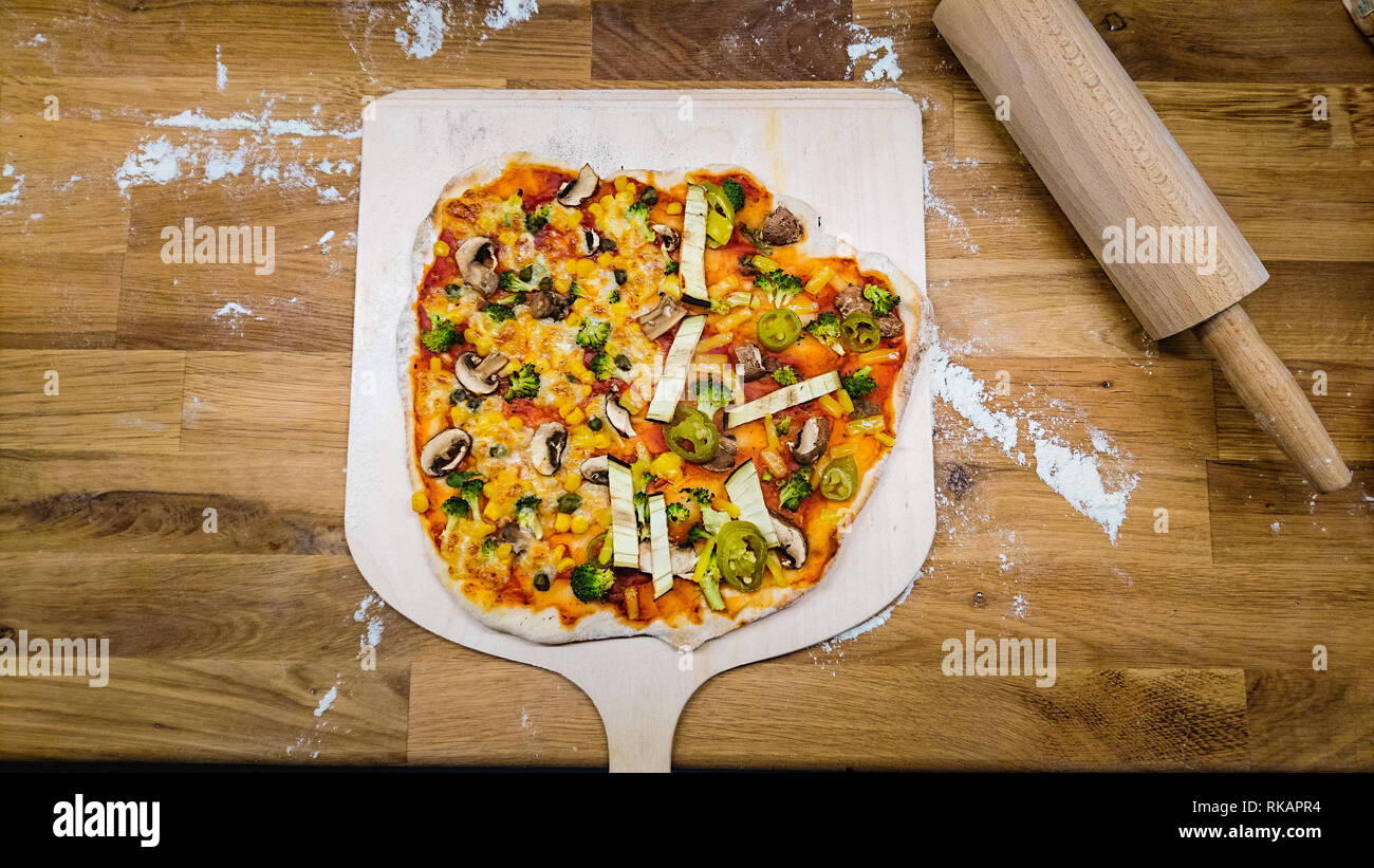 Top view of a self made pizza on a pizza shovel Stock Photo - Alamy