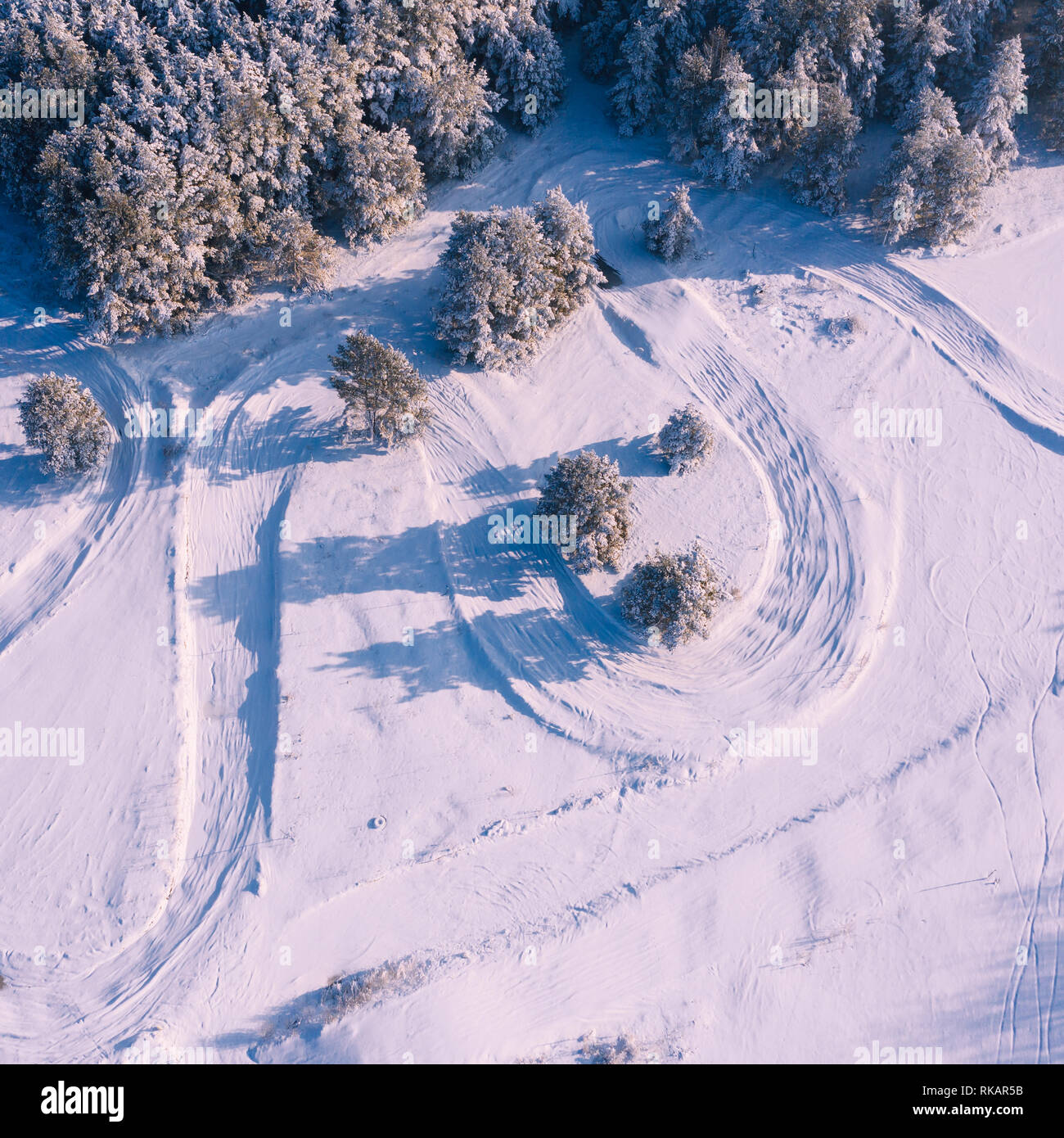 Aerial view of the winter snow covered forest and frozen lake from ...