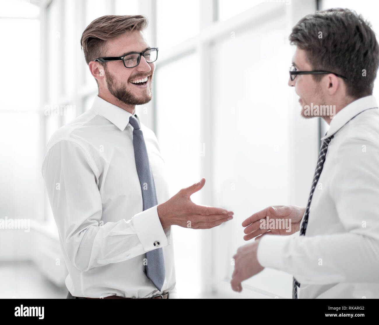 close up. employees talking, standing near the office window.business ...
