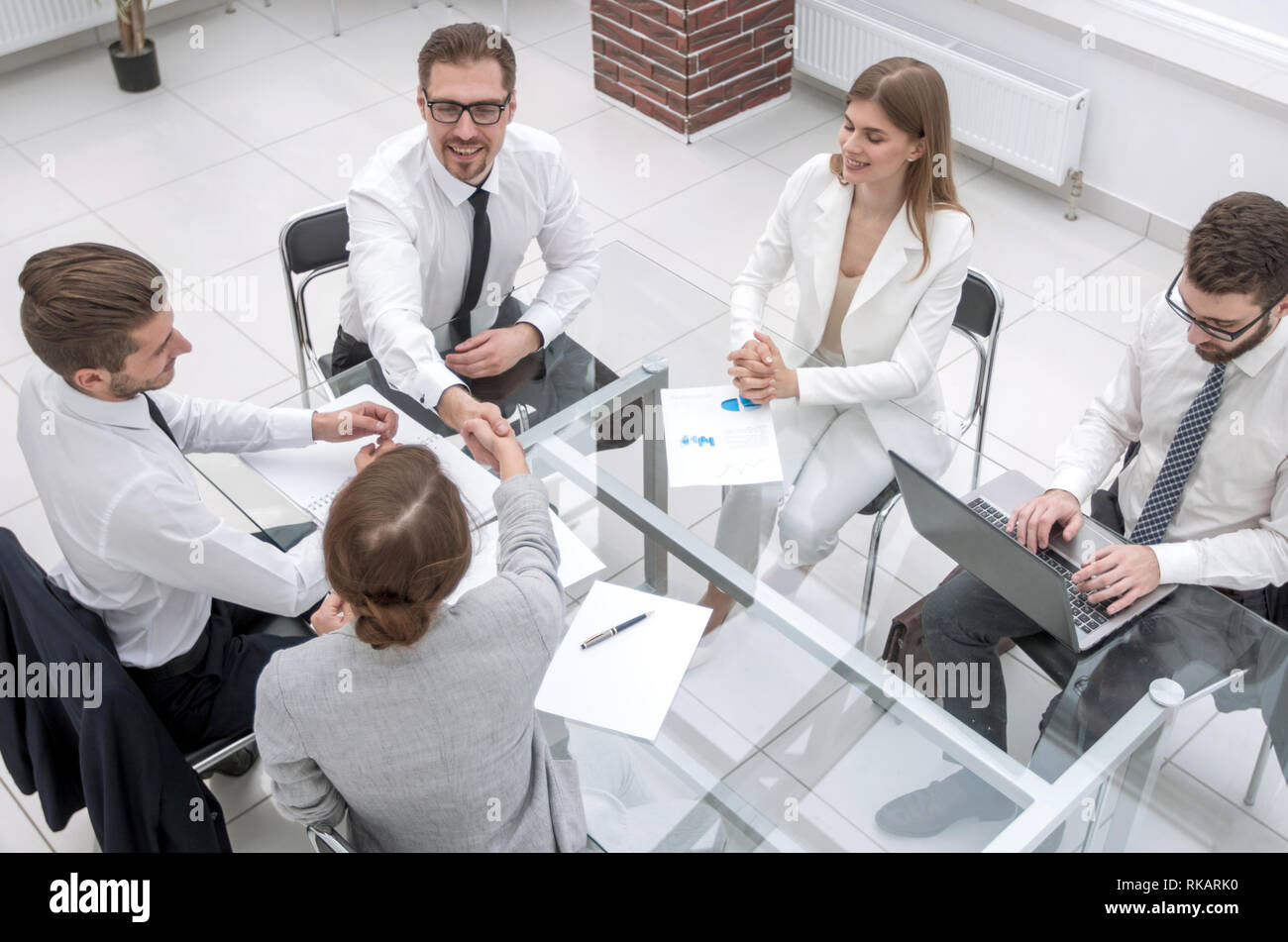 top view.handshake business partners at the negotiating table.concept ...