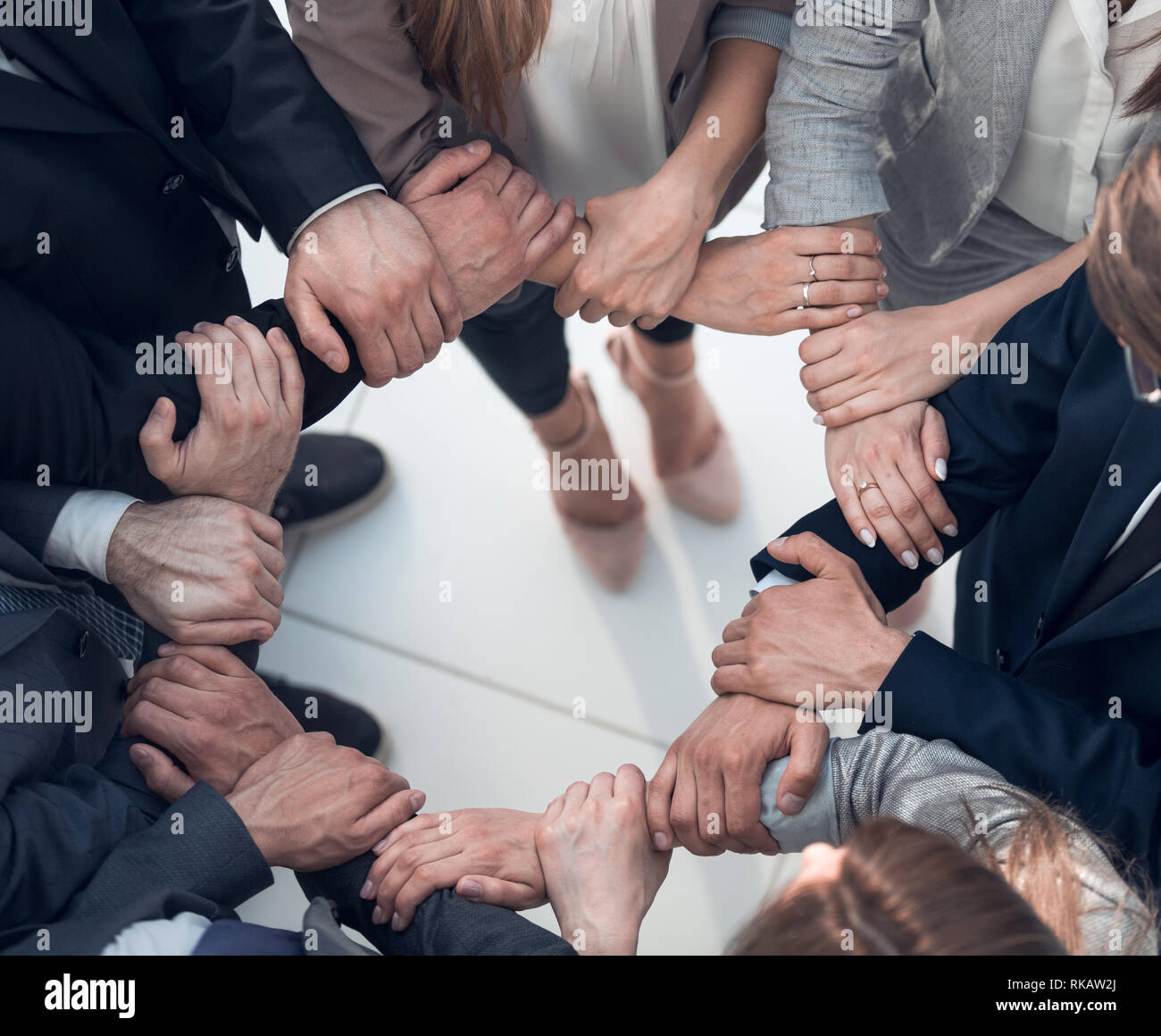 group of employees forming a circle out of hands.the concept of team ...