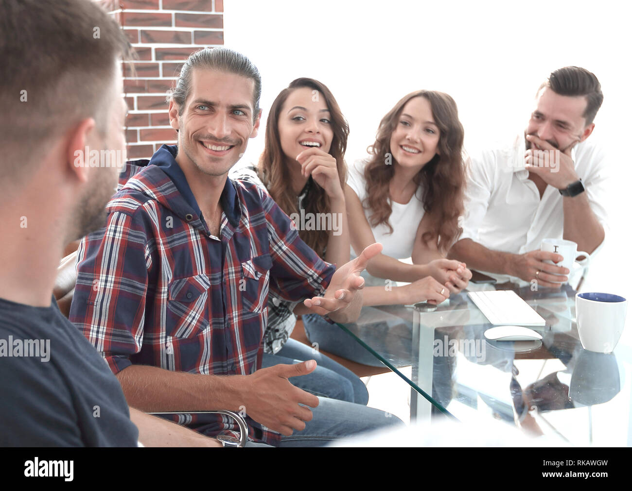 creative team discussing business issues sitting behind a Desk Stock ...