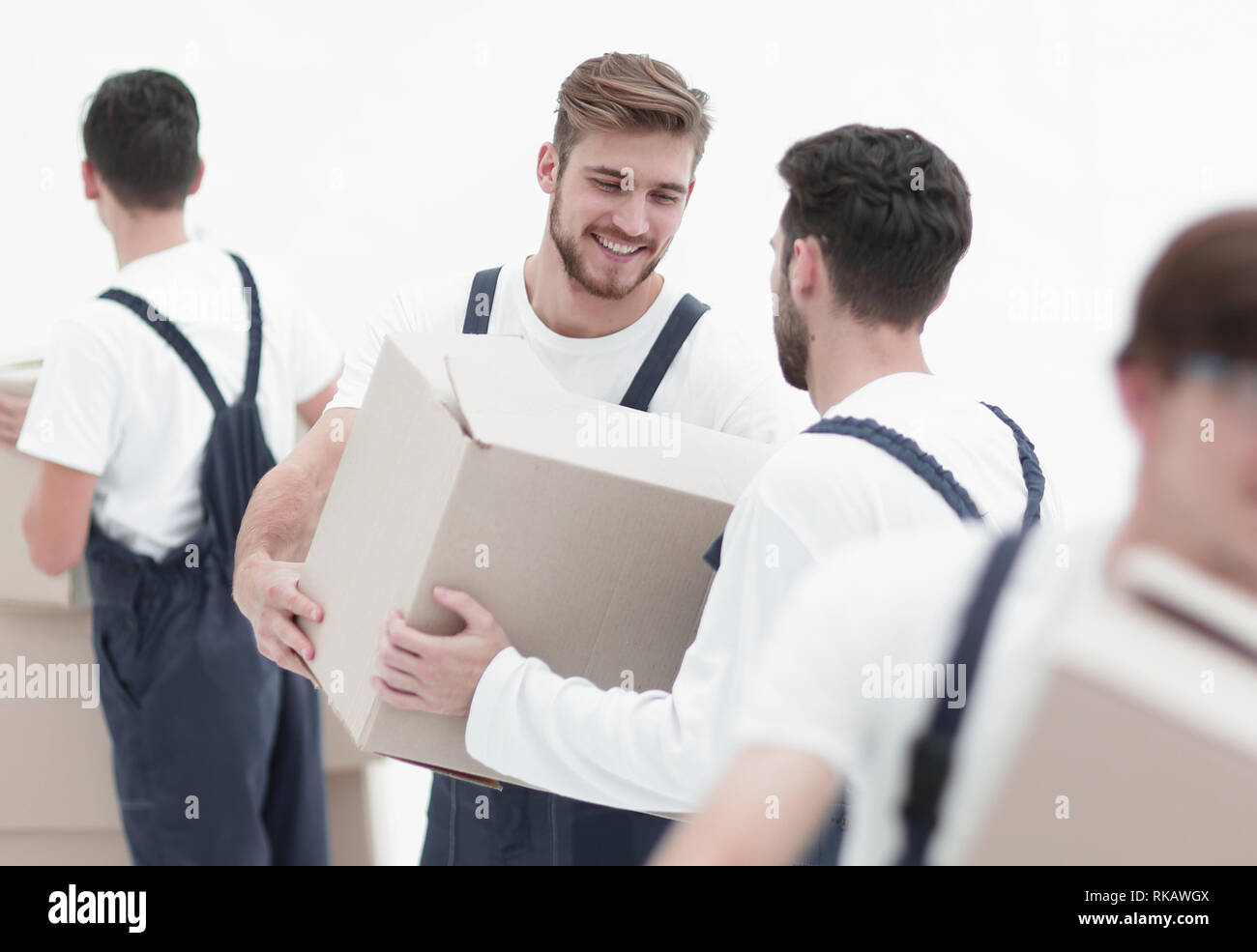 Men delivering box isolated on white Stock Photo - Alamy