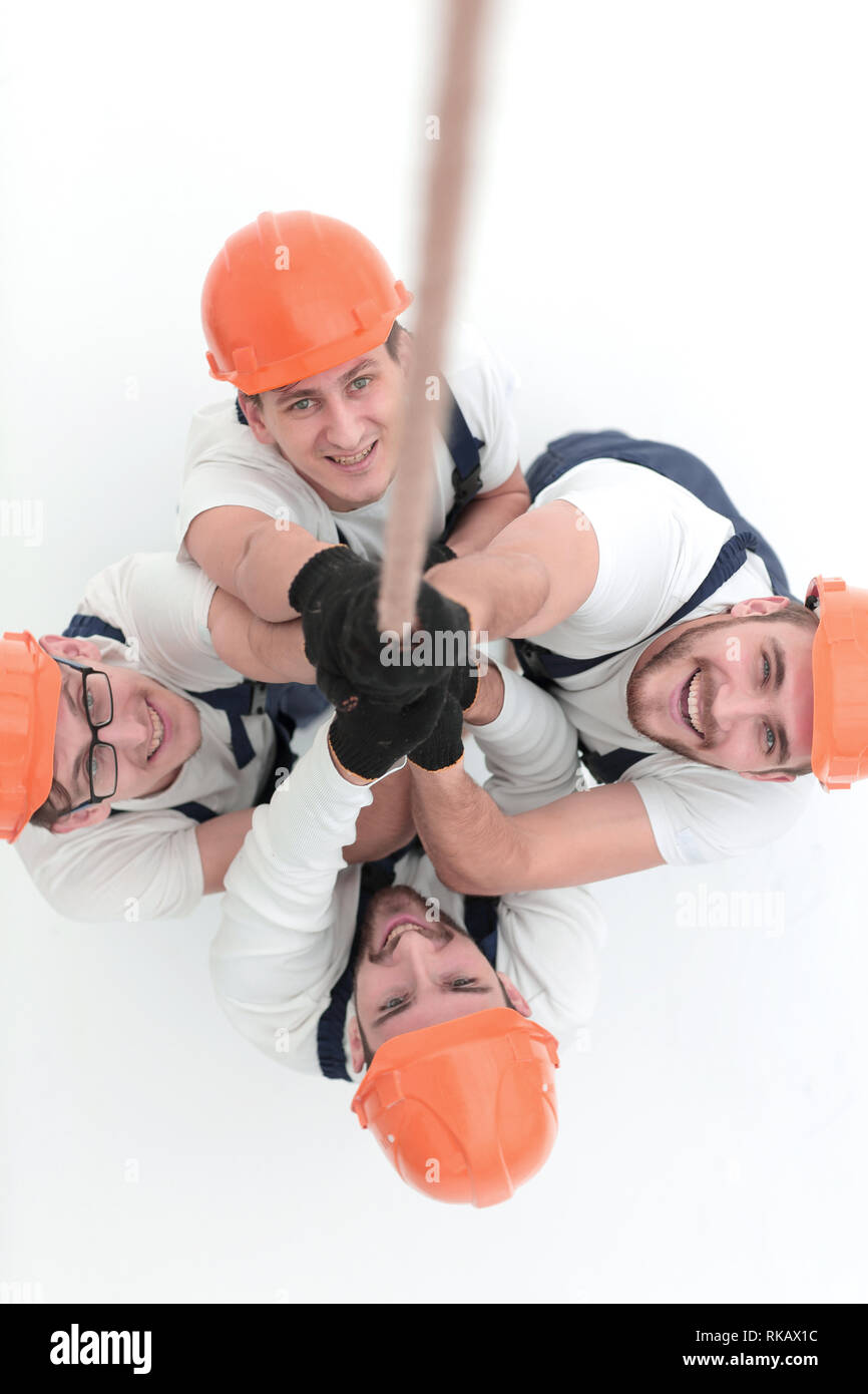 view from the top.a group of workers pulling a rope .isolated on white ...