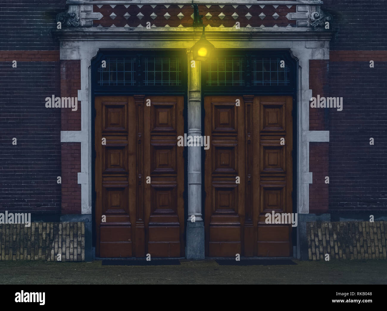 beautiful wooden entrance doors with a lighted lantern at night, modern ...