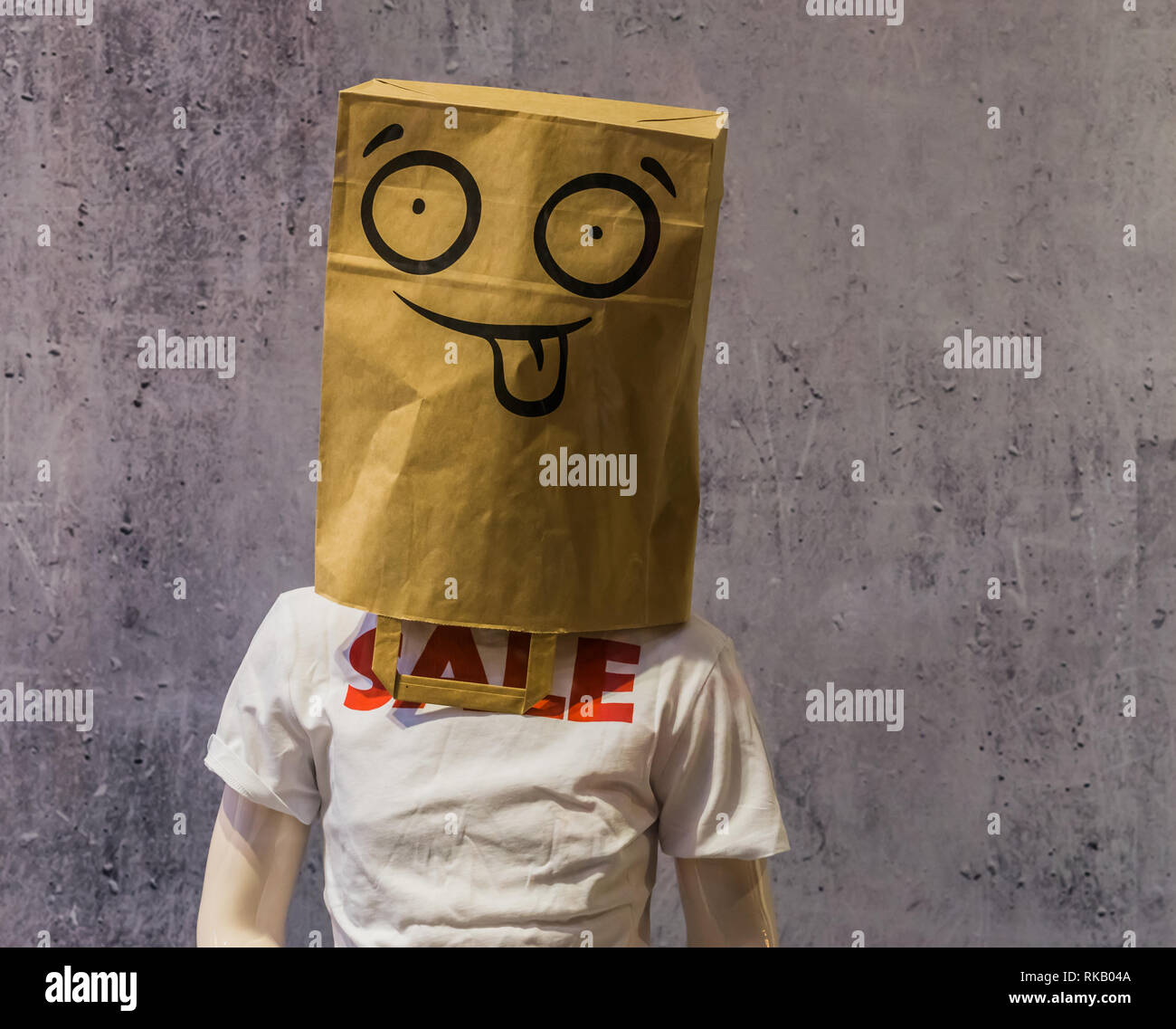 dummy wearing a funny paper bag on its head and a t-shirt with Sale on ...