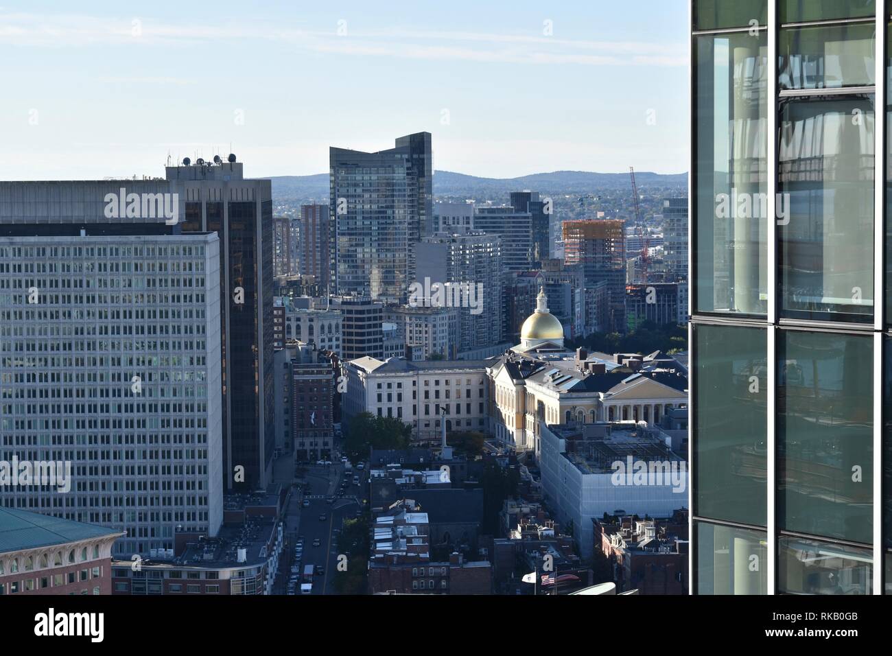 The gold dome of the Massachusetts State House atop Beacon Hill against ...