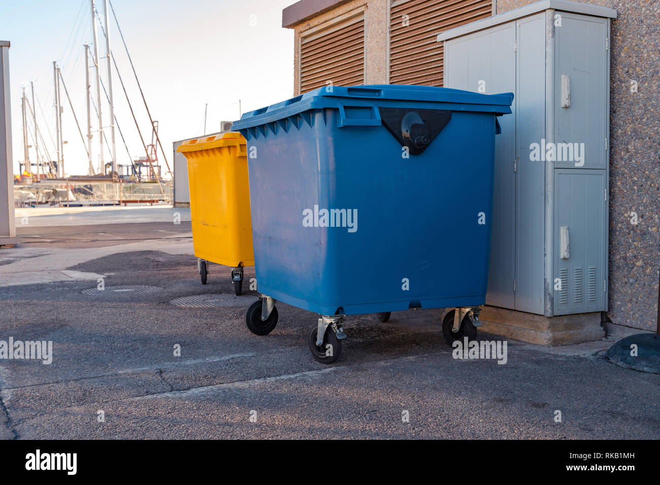Garbage containers. Blue and yellow recycling containers Stock Photo ...