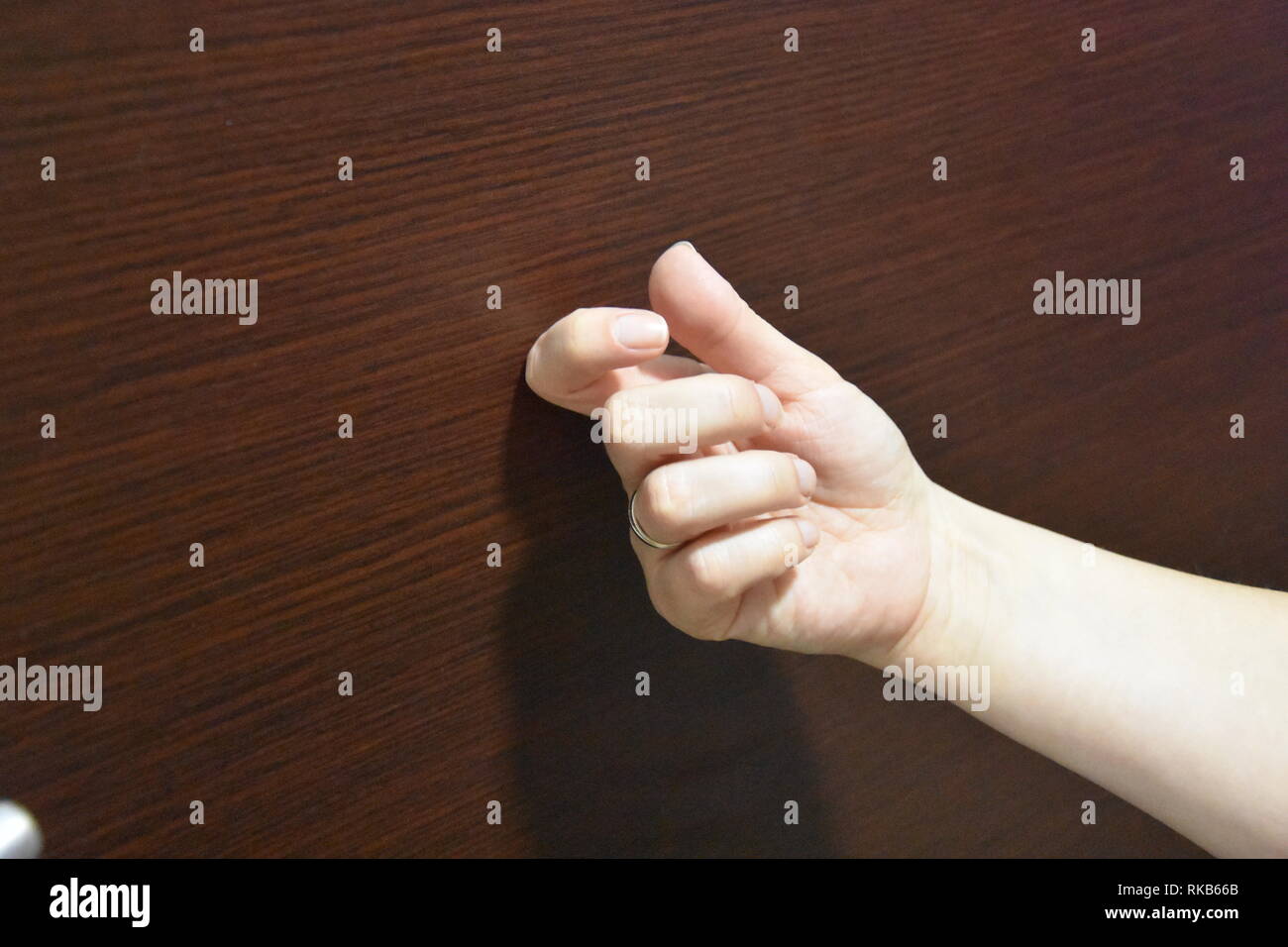 hand is knocking on wooden doo Stock Photo - Alamy