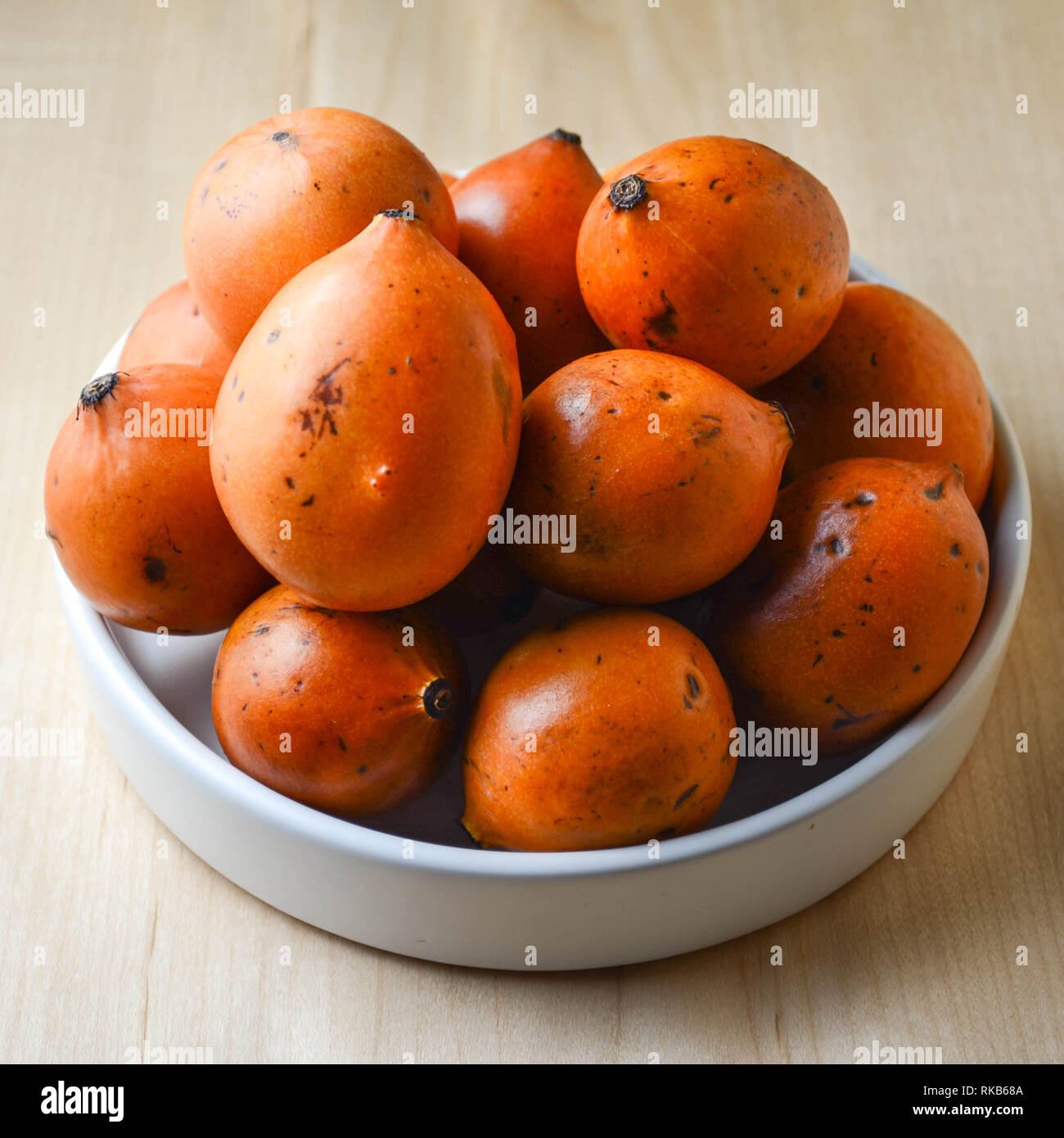 Achacha fruit (aka achachairu or Garcinia humilis) in a white bowl on a ...