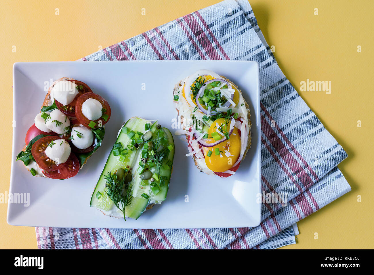 Variety of sandwiches or tapas with bread , cream cheese, vegetable and ...