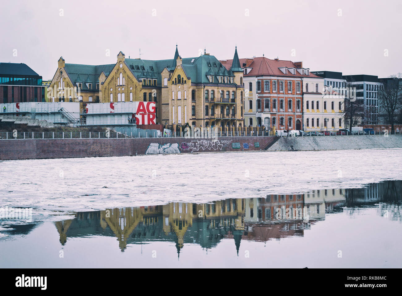 architecture reflecting on a half frozen river in Wroclaw Stock Photo ...