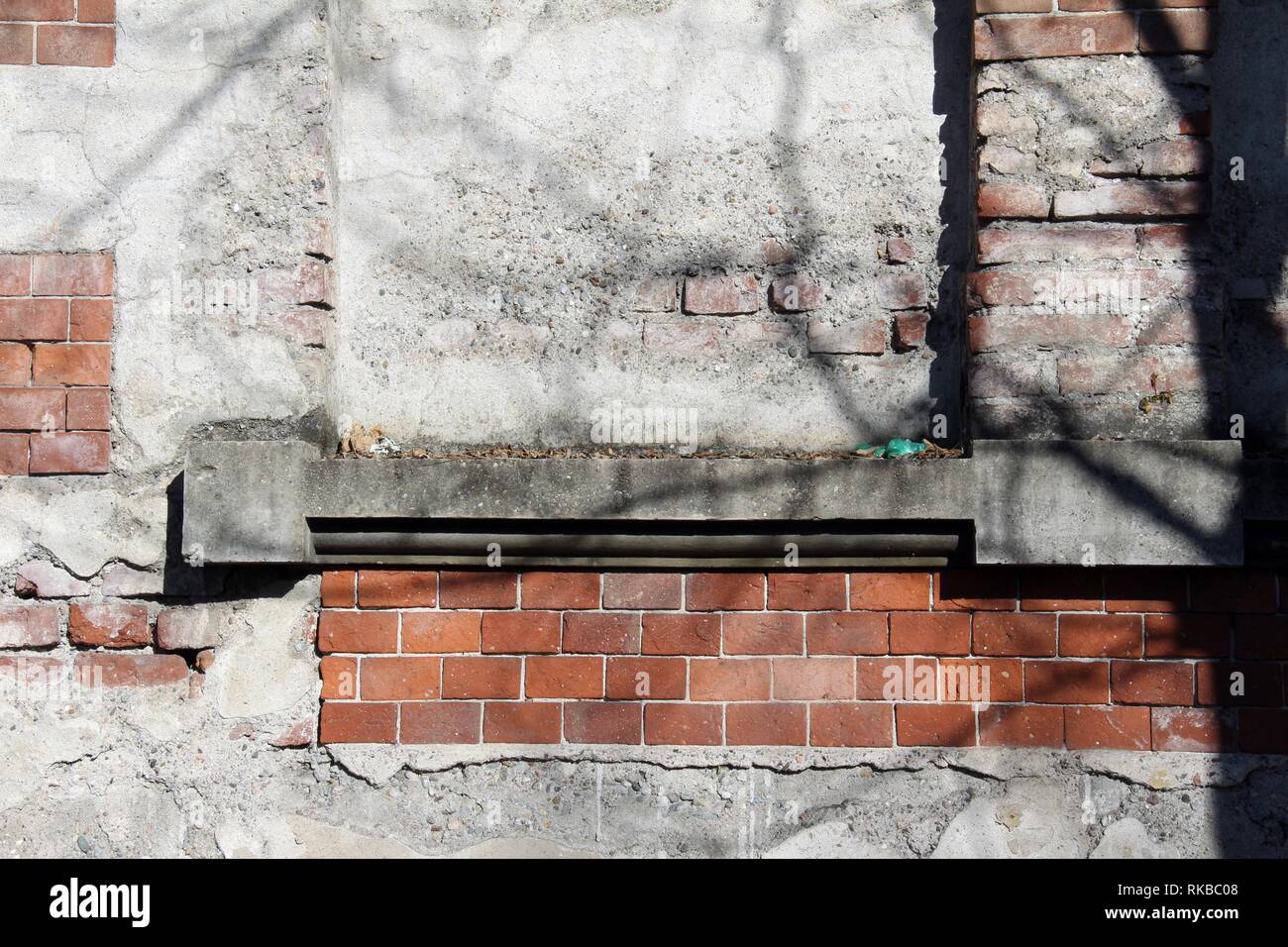 The old wall hides a window, which has been walled, with a small window ...