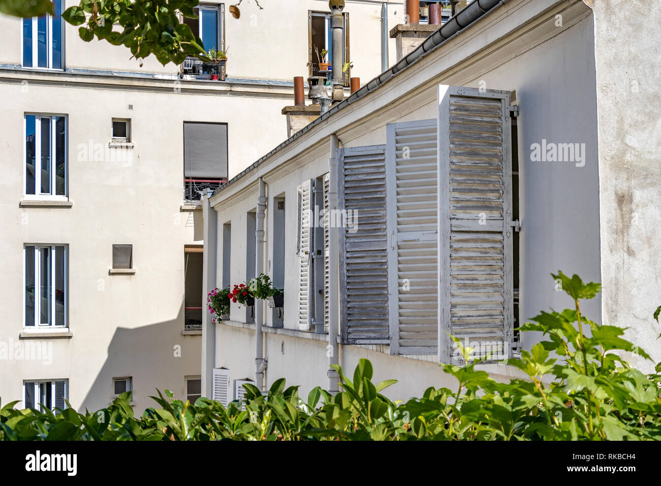 Paris apartments with white wooden shutters on the windows,seen from ...