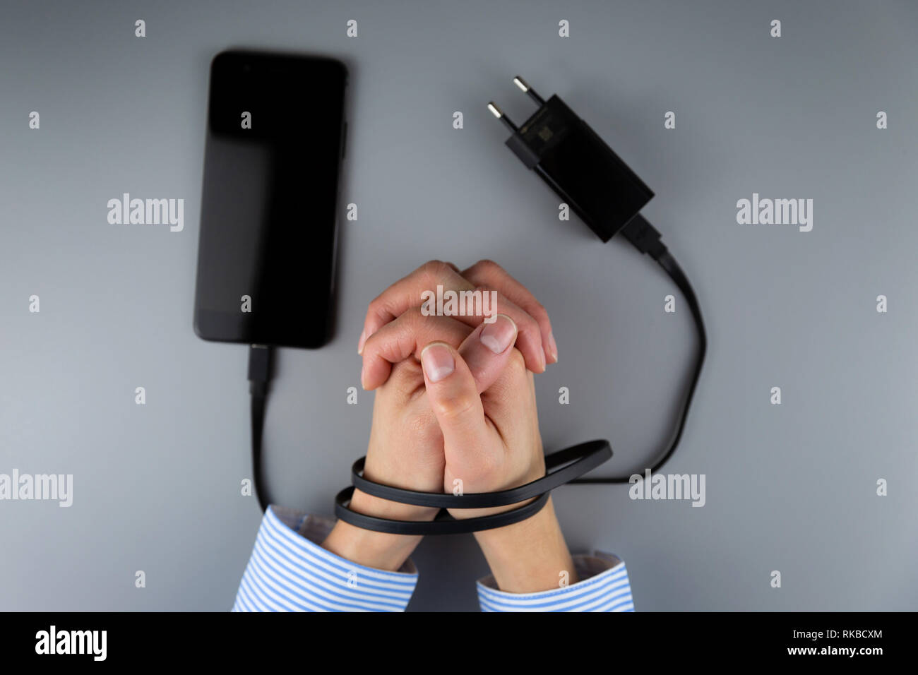 Female hands and smartphone. Woman's hands trapped and wrapped on ...