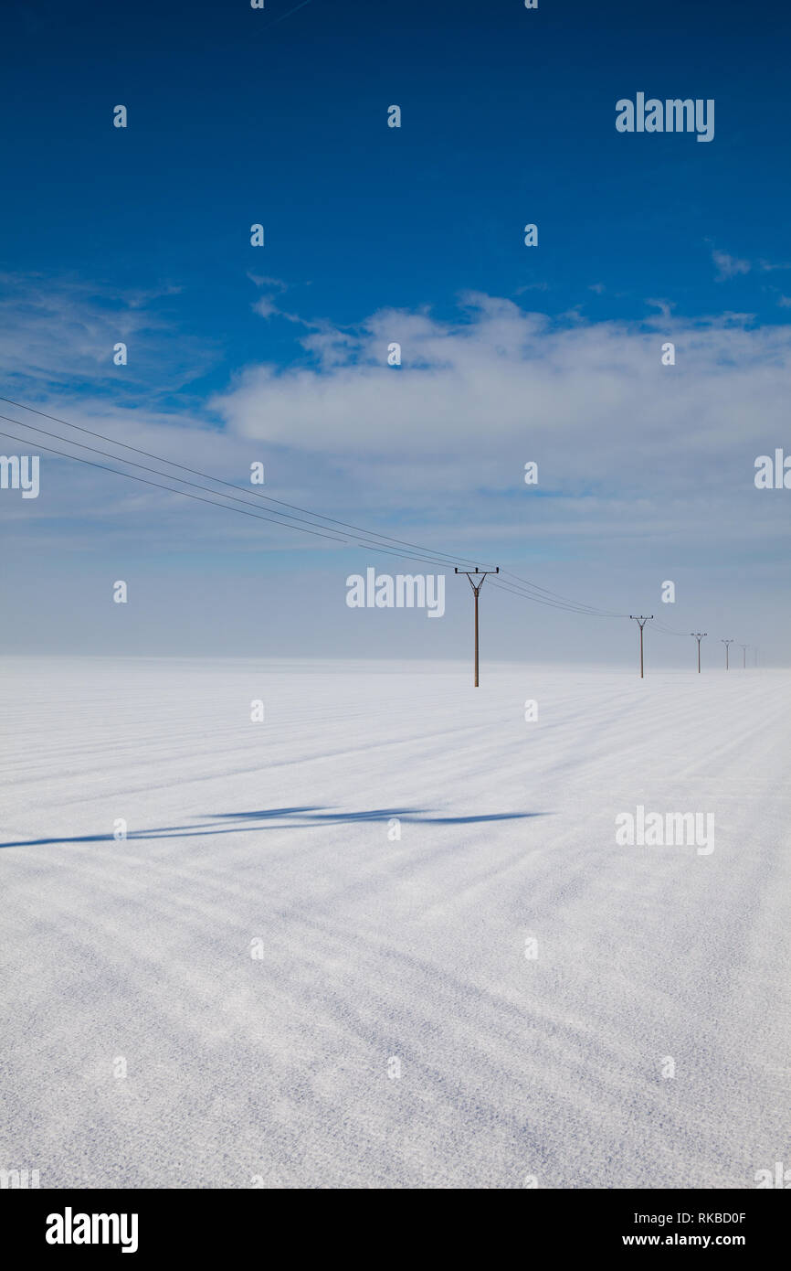Winter landscape with power line columns a snow covered field Stock ...