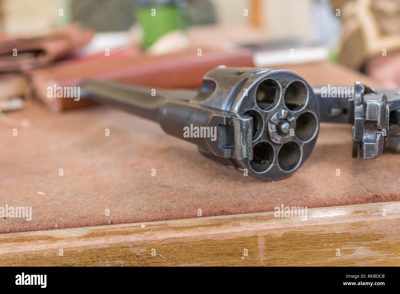 British WW1 Webley .455 revolver lying on on wooden table broken open ...