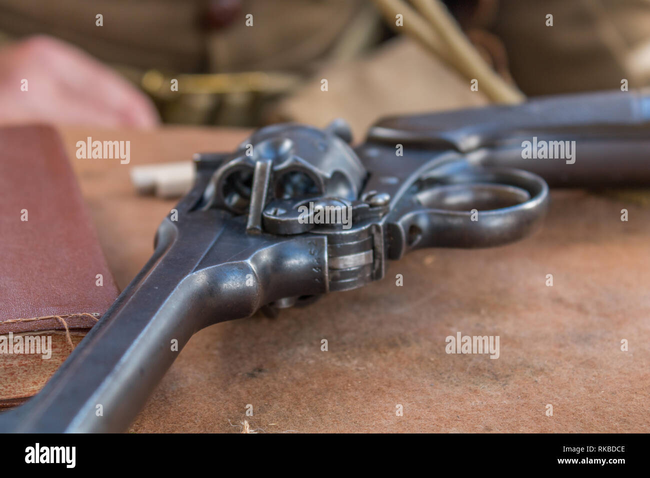 British WW1 Webley .455 revolver lying on book on wooden table Stock ...