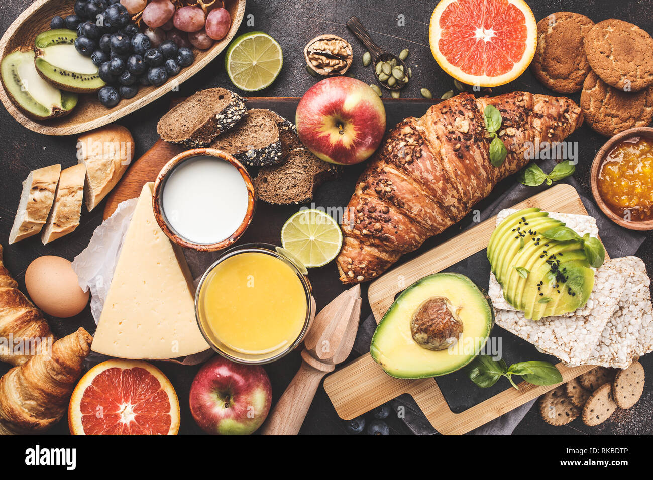 Healthy balanced breakfast on a dark background. Muesli, milk, juice ...
