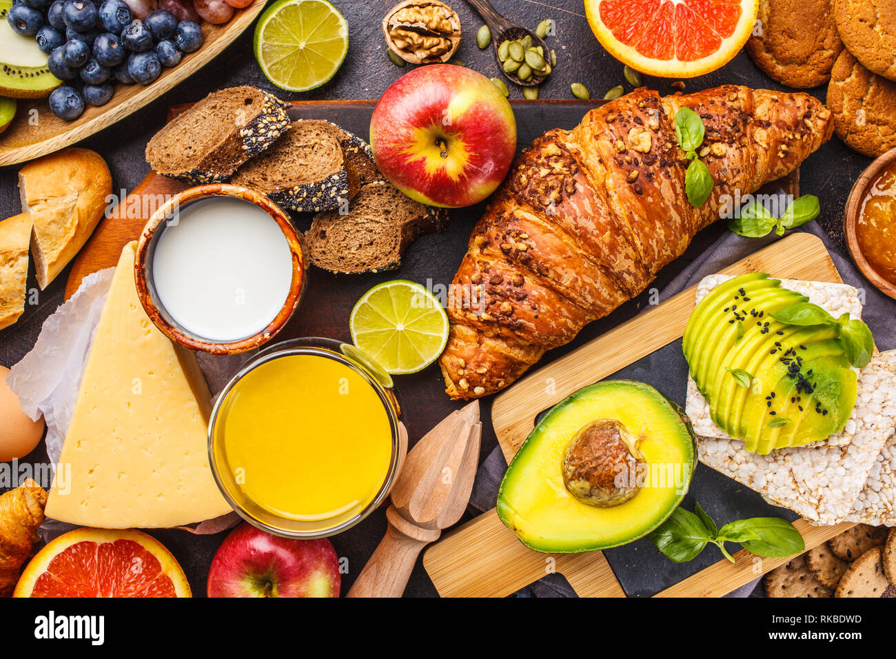 Healthy balanced breakfast on a dark background. Muesli, milk, juice ...