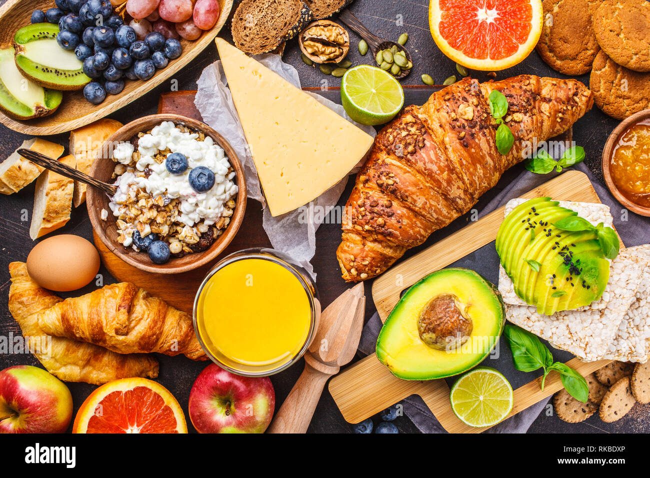Healthy balanced breakfast on a dark background. Muesli, milk, juice ...
