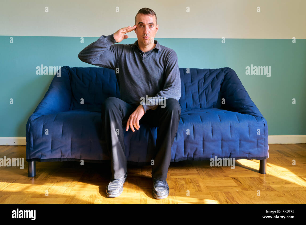 Handsome guy posing - attractive man saluting with hands Stock Photo ...