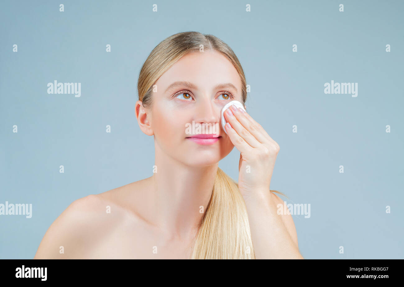 Beautiful woman removing makeup from her face, skin care concep Stock ...