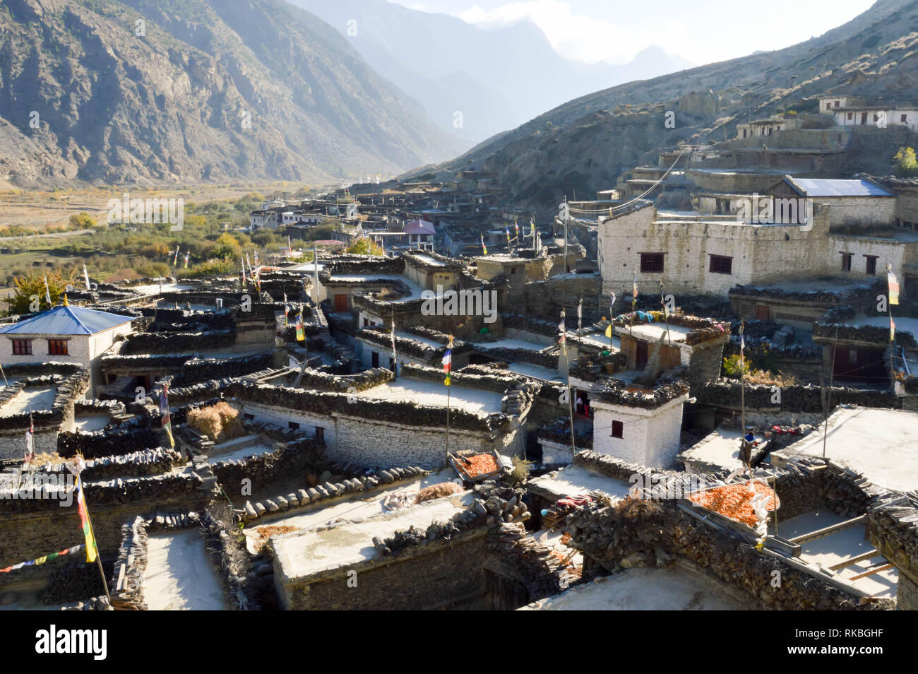 The village of Marpha in autumn sunshine with bright orange sweetcorn ...