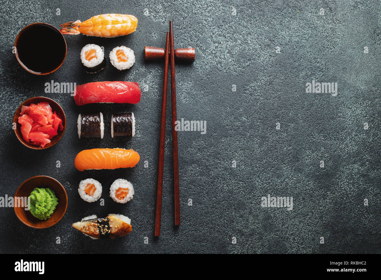 Set of sushi and maki on dark stone table. Top view with copy space ...