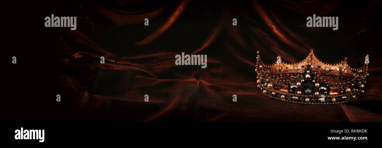 banner of gold crown over gothic dark silk background. Medieval period ...