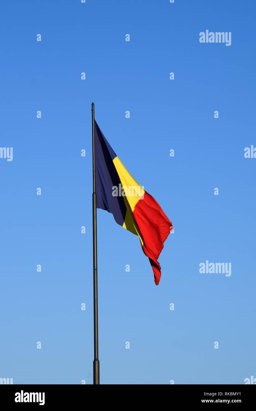 Romanian flag waving in the wind in front of a clean blue sky. Romania ...