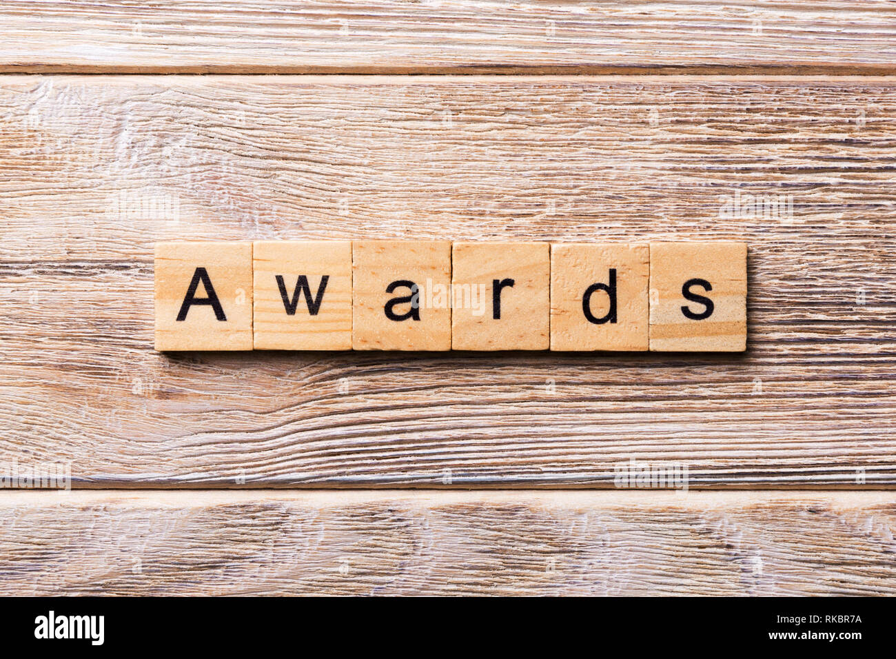 AWARDS word written on wood block. AWARDS text on wooden table for your ...
